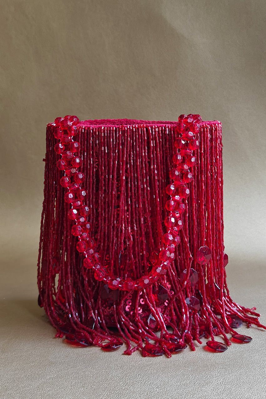 Red glamorous embellished potli with swaying tassels - Plode | Mrs. G